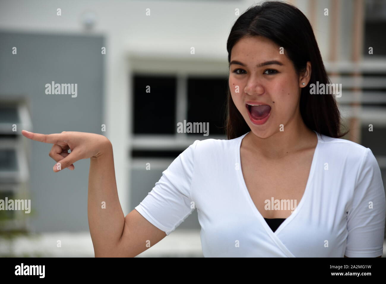 A Youthful Minority Woman Pointing Stock Photo - Alamy