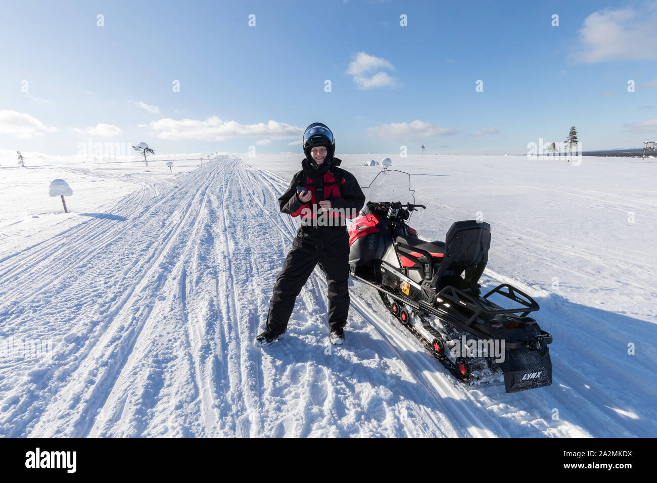 Woman driving snowmobile at arctic winter wonderland Lapland Stock ...
