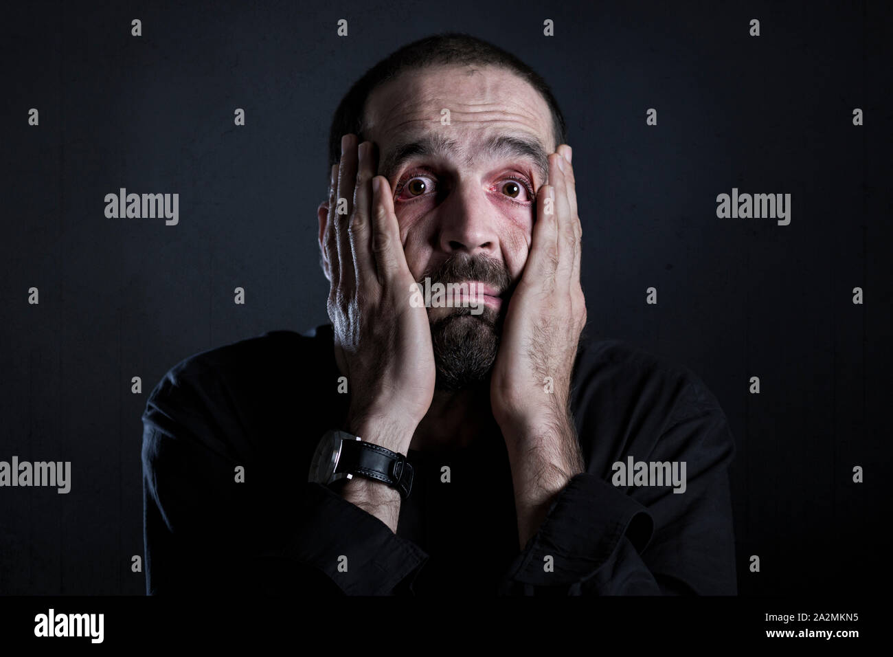 Despaired man looking exhausted and tired Stock Photo - Alamy