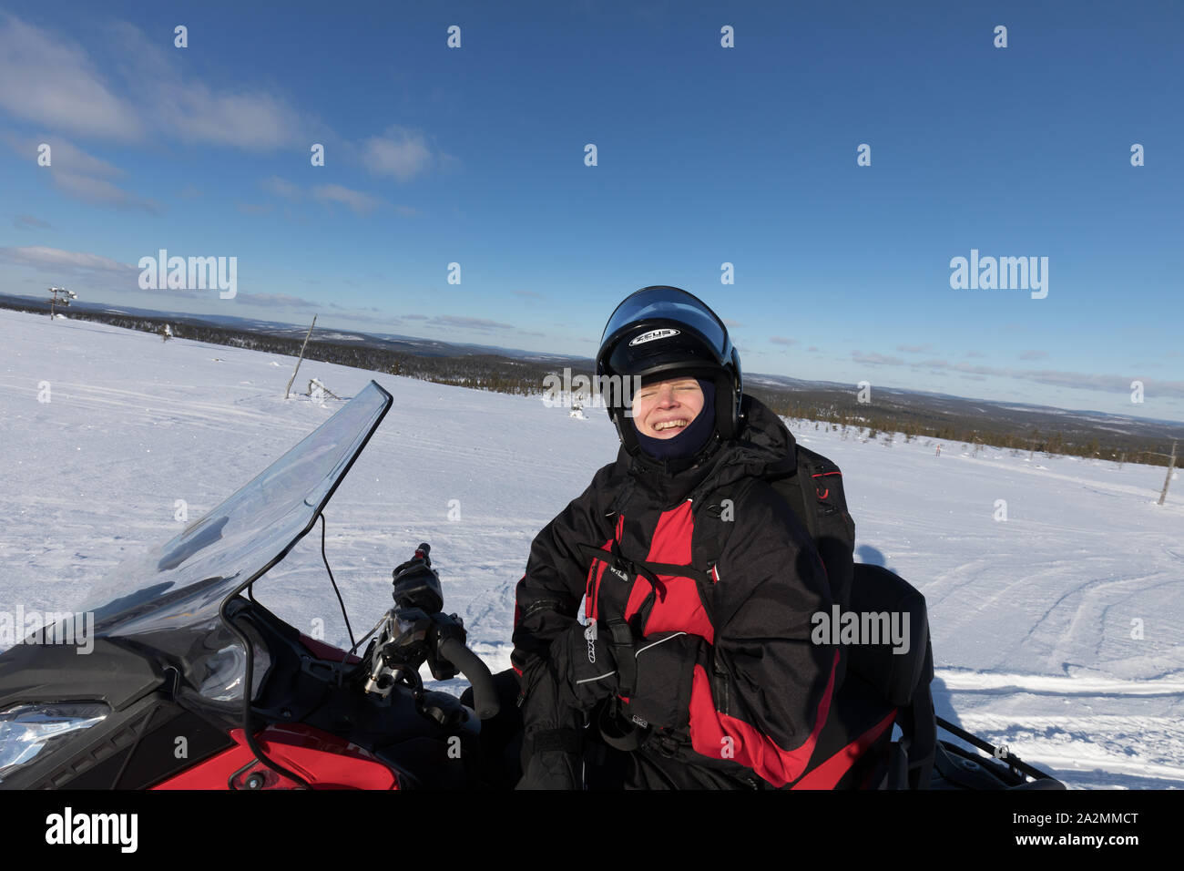 Woman driving snowmobile at arctic winter wonderland Lapland Stock ...