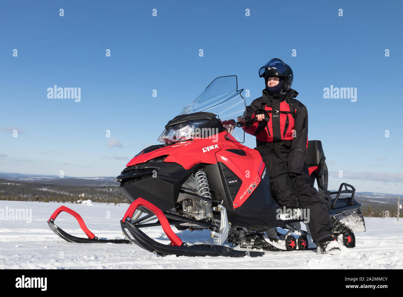 Woman driving snowmobile at arctic winter wonderland Lapland Stock ...