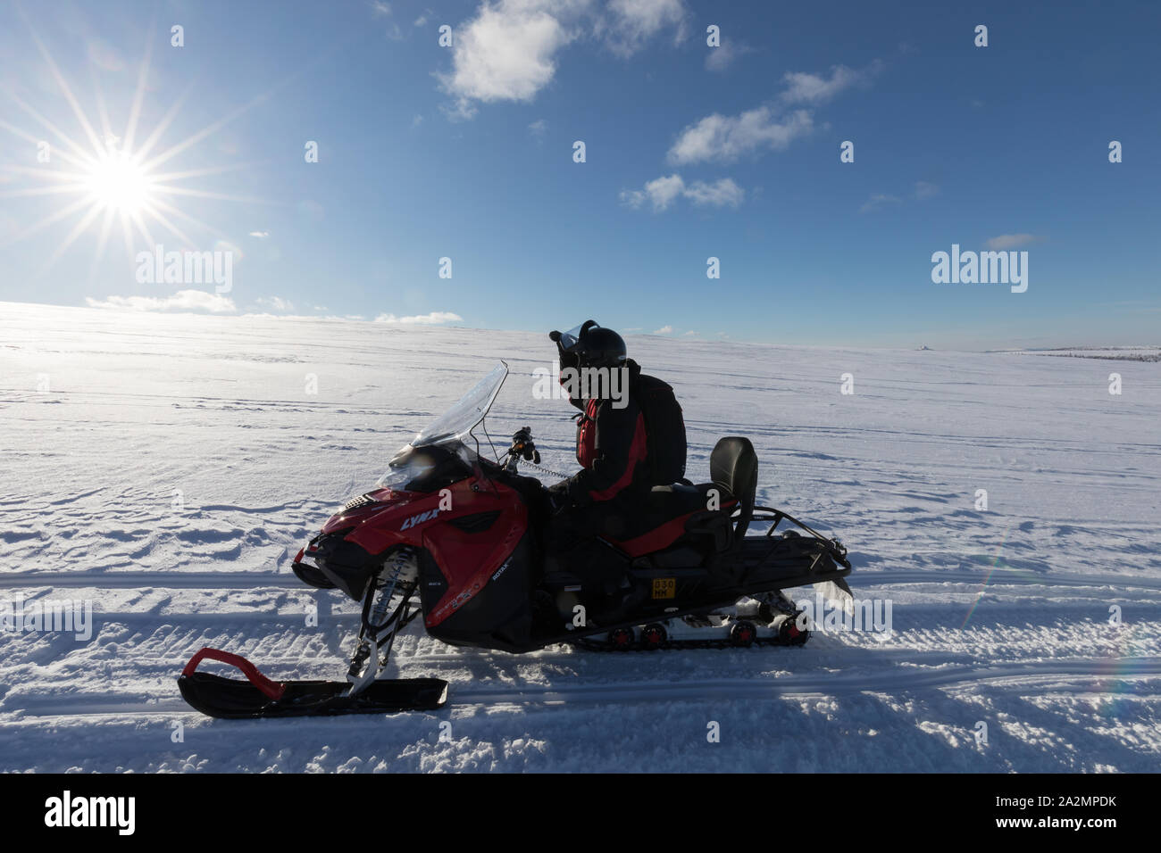 Woman driving snowmobile at arctic winter wonderland Lapland Stock ...