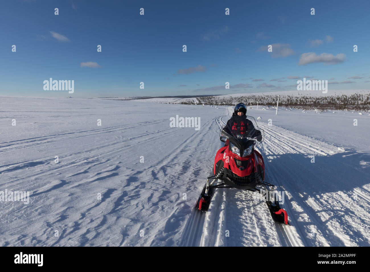 Woman driving snowmobile at arctic winter wonderland Lapland Stock ...