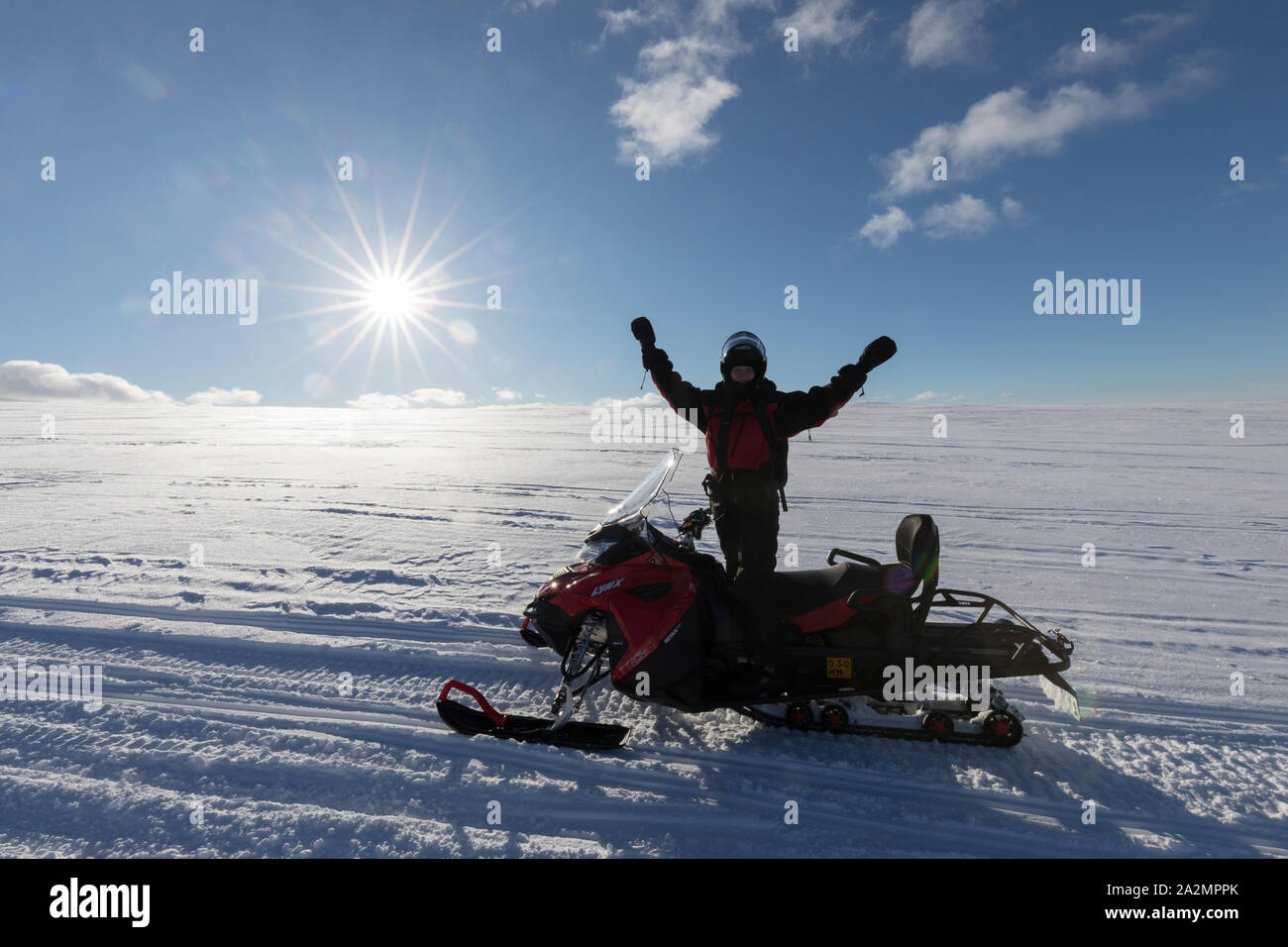 Woman driving snowmobile at arctic winter wonderland Lapland Stock ...