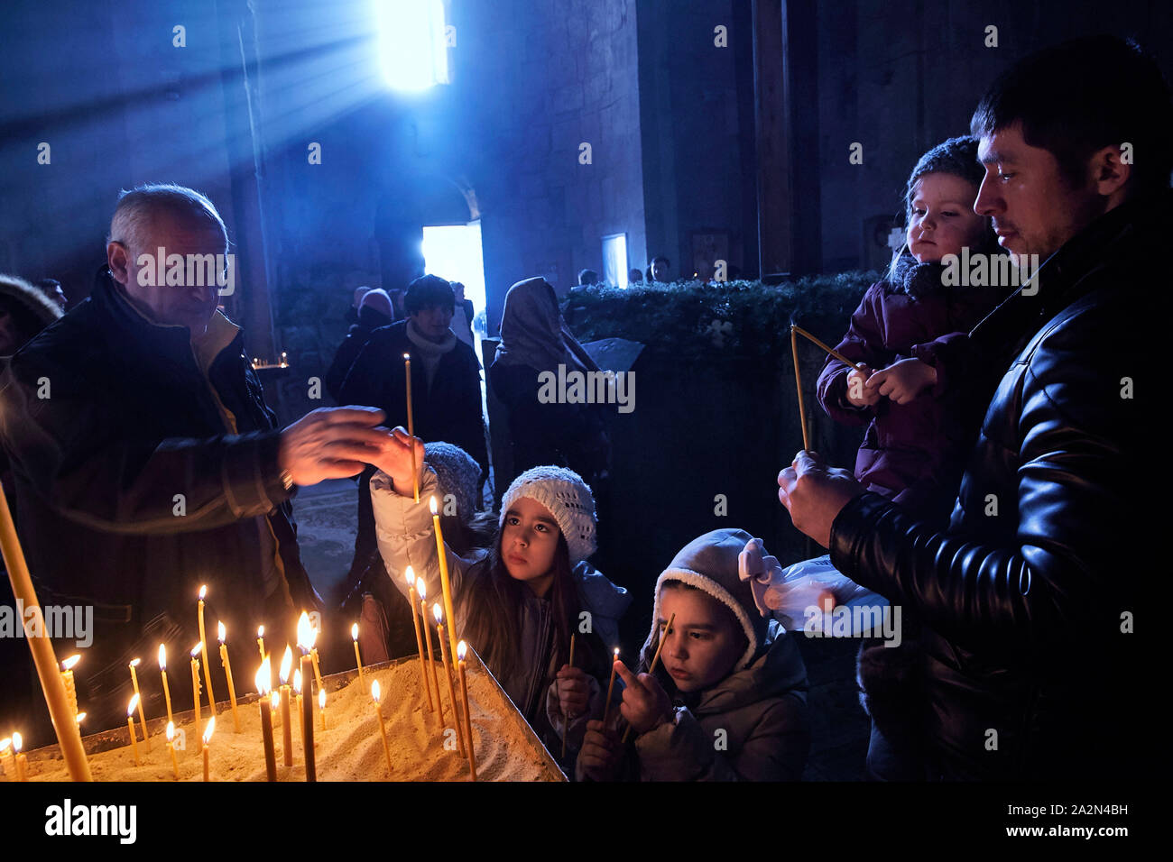Georgia Karsani St Nino Church children and parents with candles 19-01 ...