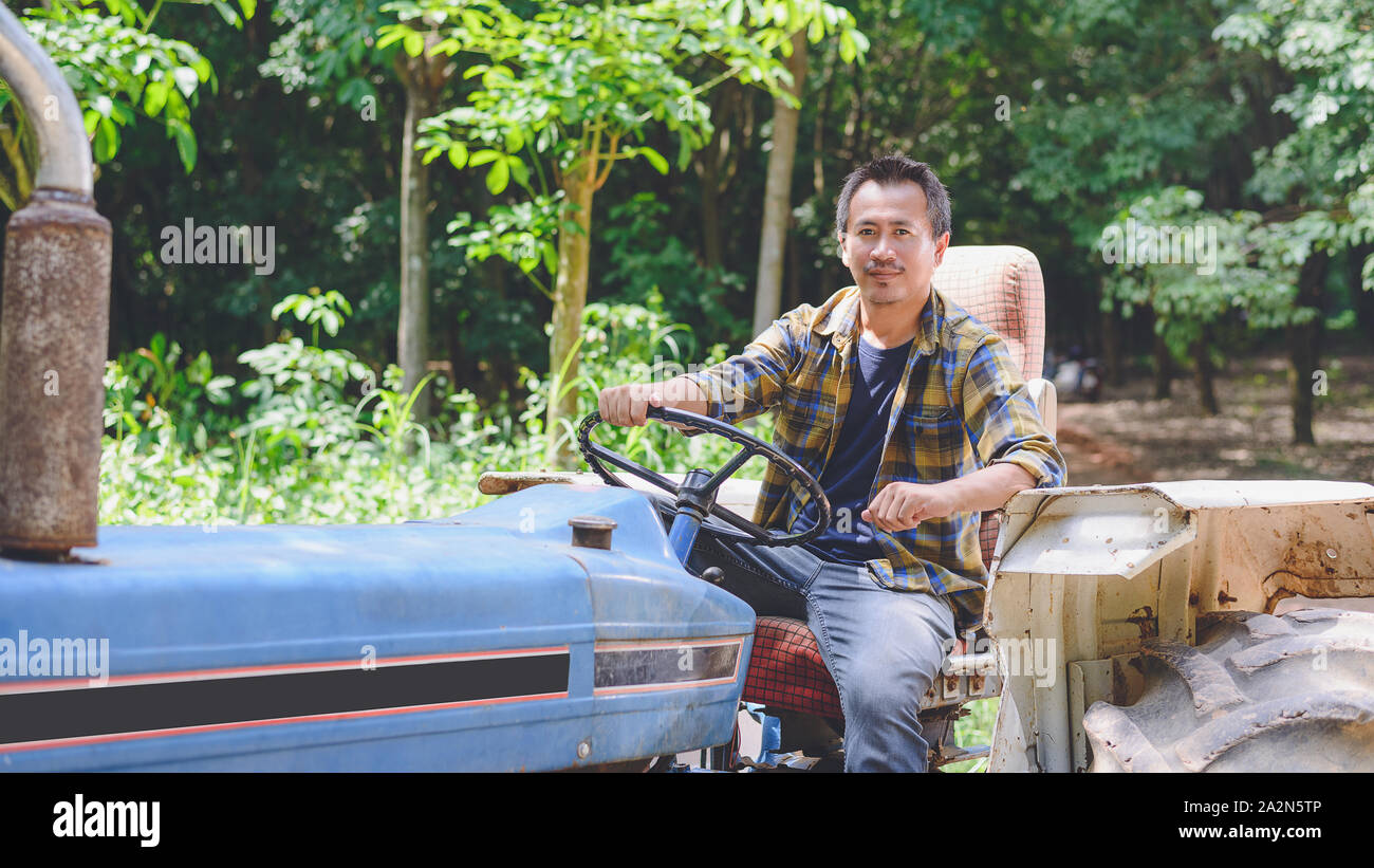Young man sitting on tractor hi-res stock photography and images - Alamy