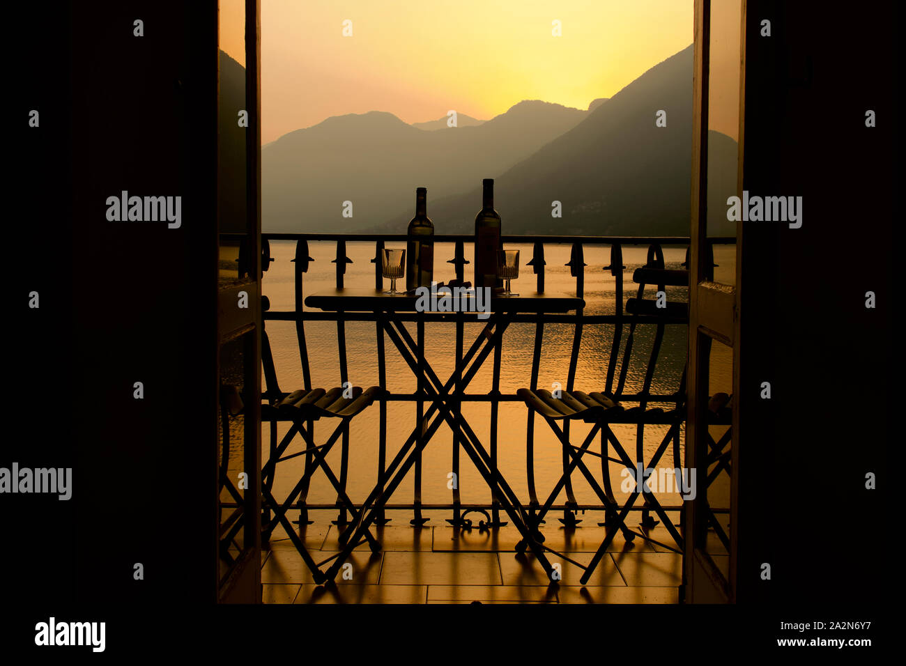 A romantic balcony setting at sunset on Lake Como, Lombardy, Italy ...