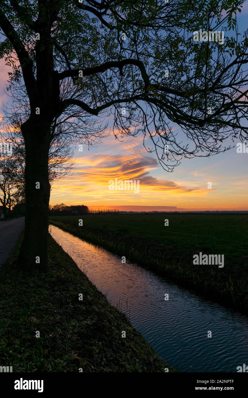 Sunset in the western Netherlands. Colorful cloud reflections in the ...