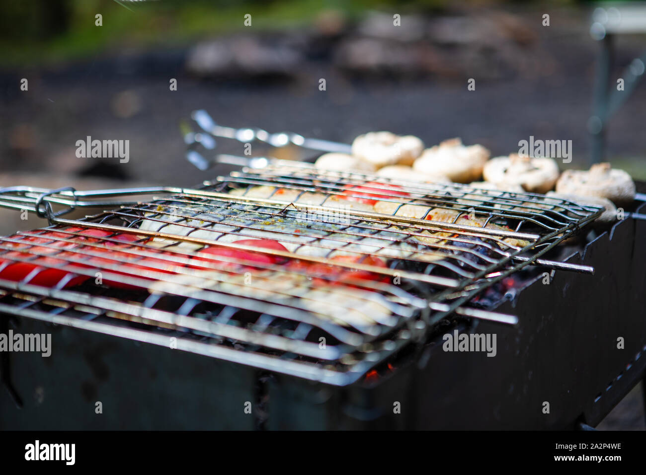 bbq concept fish on fire with mushroom and tomatoes Stock Photo - Alamy