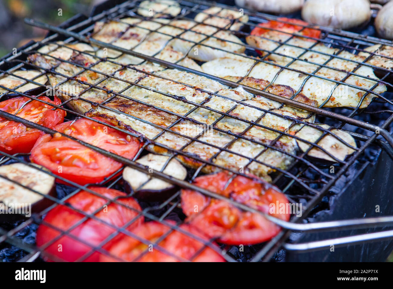 bbq concept fish on fire with mushroom and tomatoes Stock Photo - Alamy
