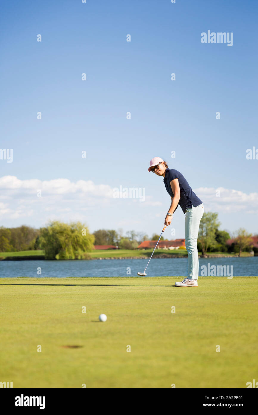 Female golfer hitting ball hi-res stock photography and images - Alamy