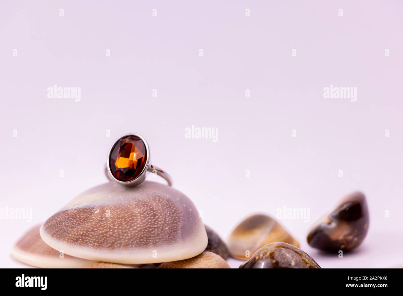 Gemstone ring gift concept. cinnamon stone ring on a seashell with ...