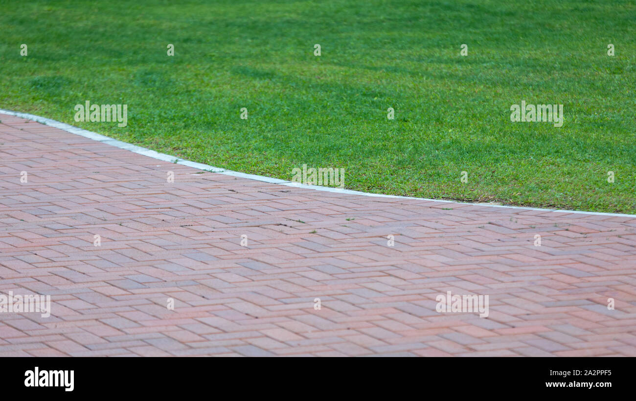 Grass and Pavement Curved Divider Line in Park Stock Photo - Alamy