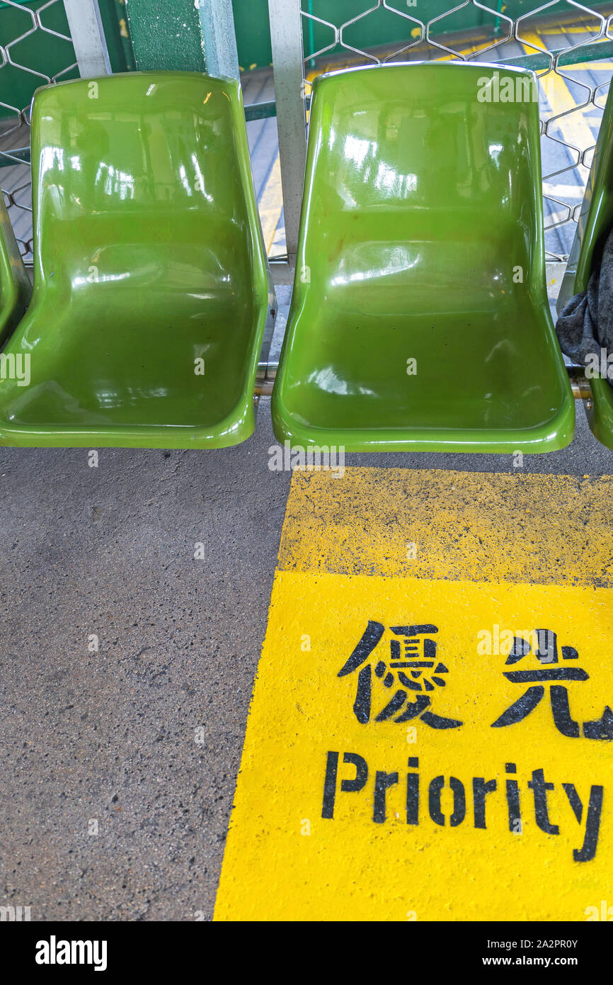 Priority Seats and Bright Yellow Stencil Warning Sign Stock Photo - Alamy