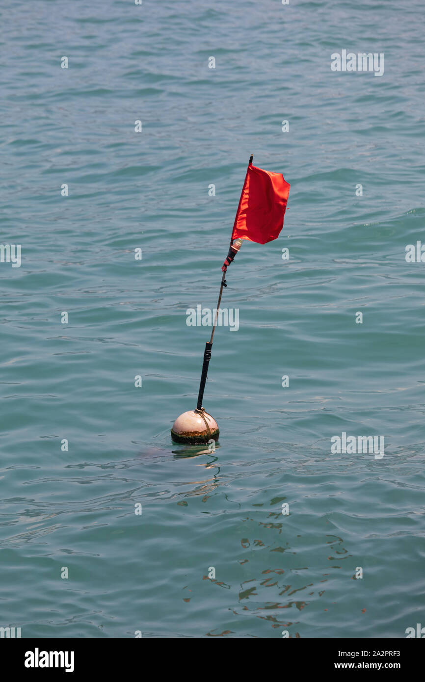 Floating Red Flag Mark in Harbour Water Warning Stock Photo - Alamy