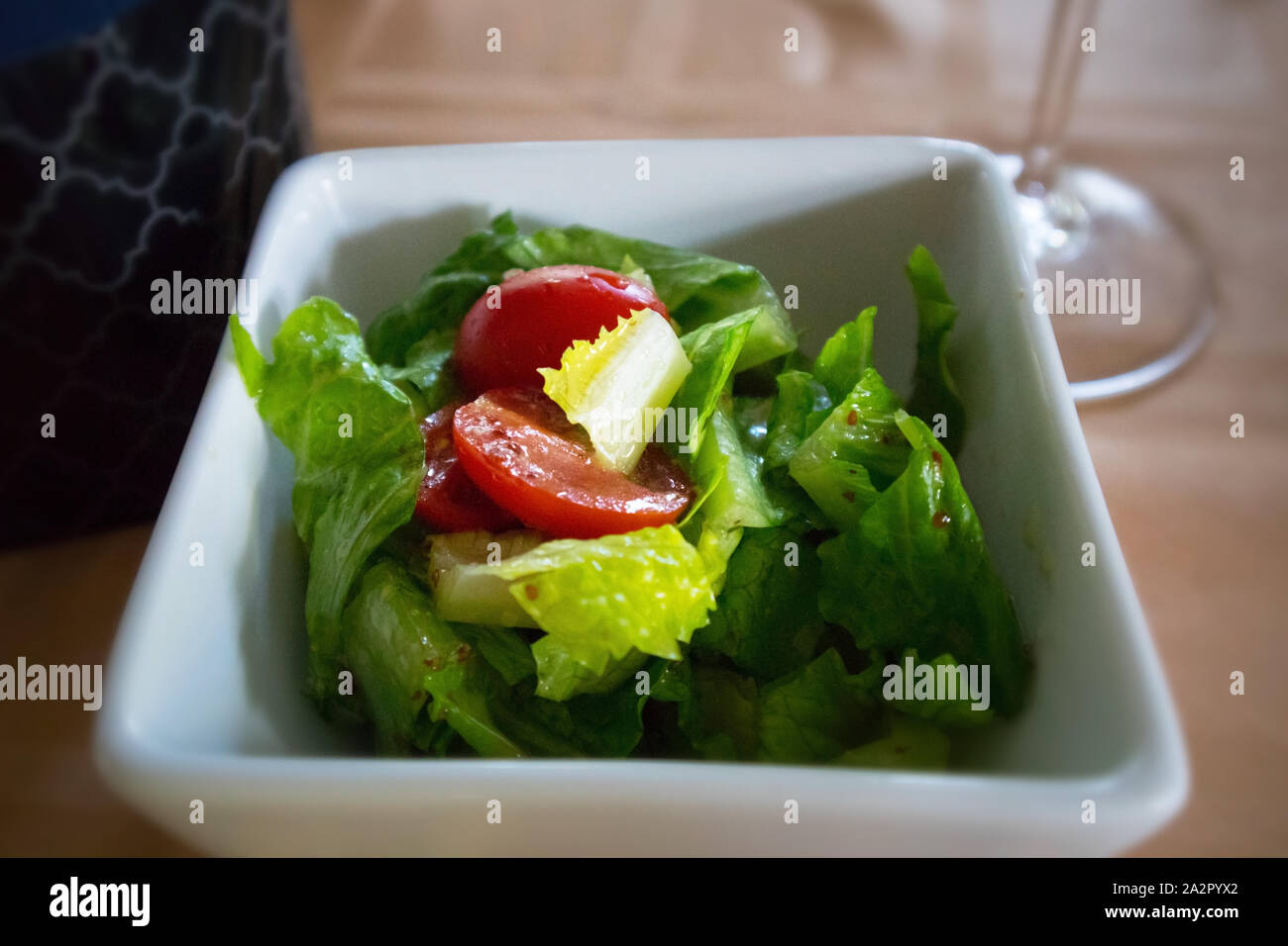 A simple lettuce and tomato salad in a square bowl Stock Photo - Alamy