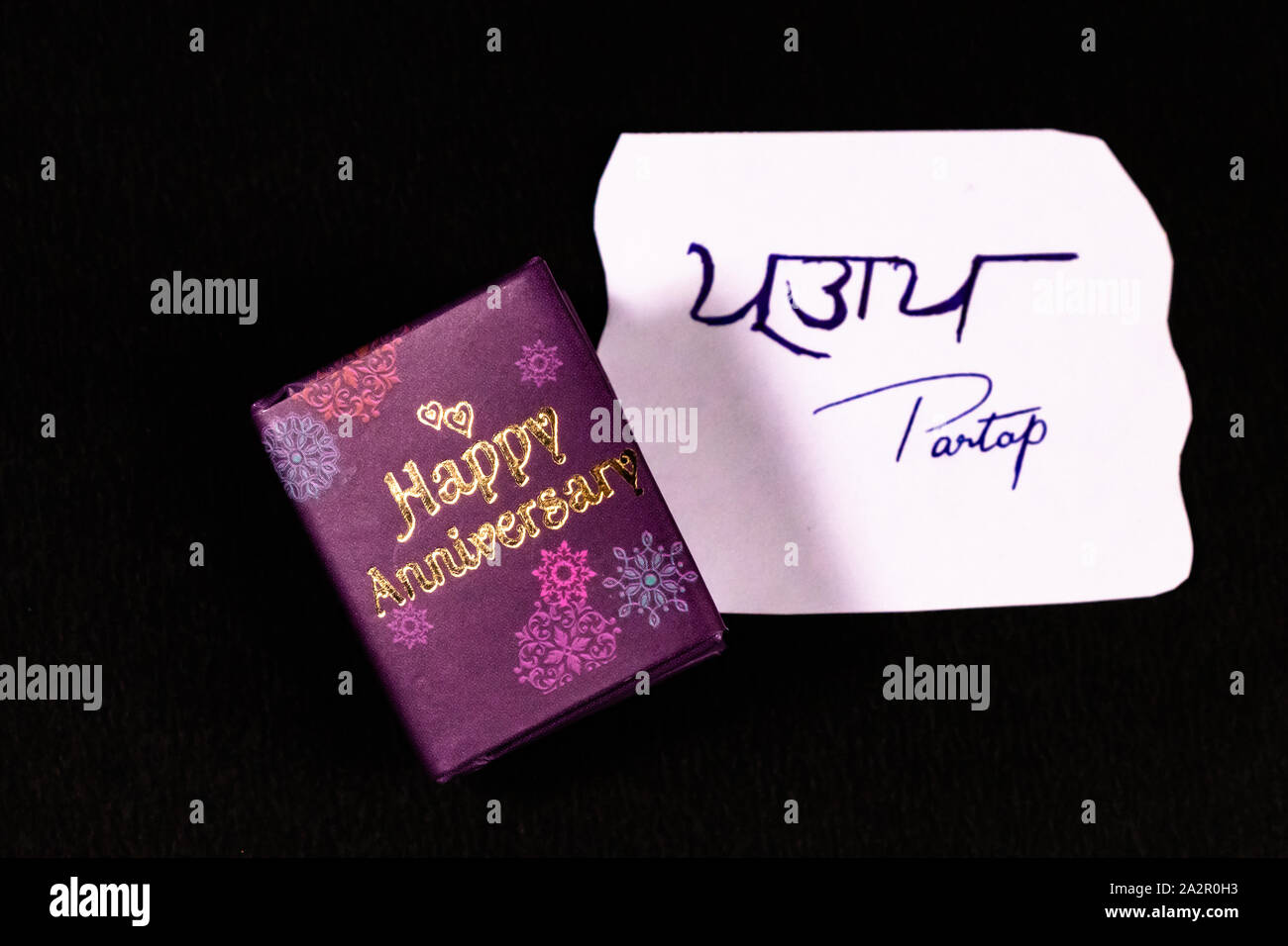 Hand written name initials on white paper and happy aniversary mini ...