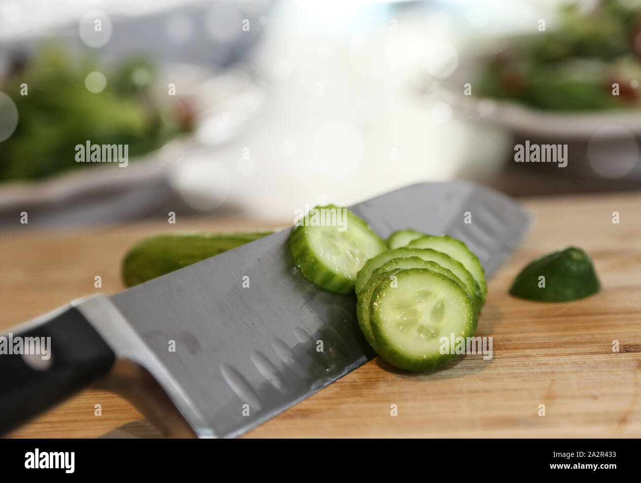 Chopping board with a cucumber being chopped. Chopped cucumber Stock ...