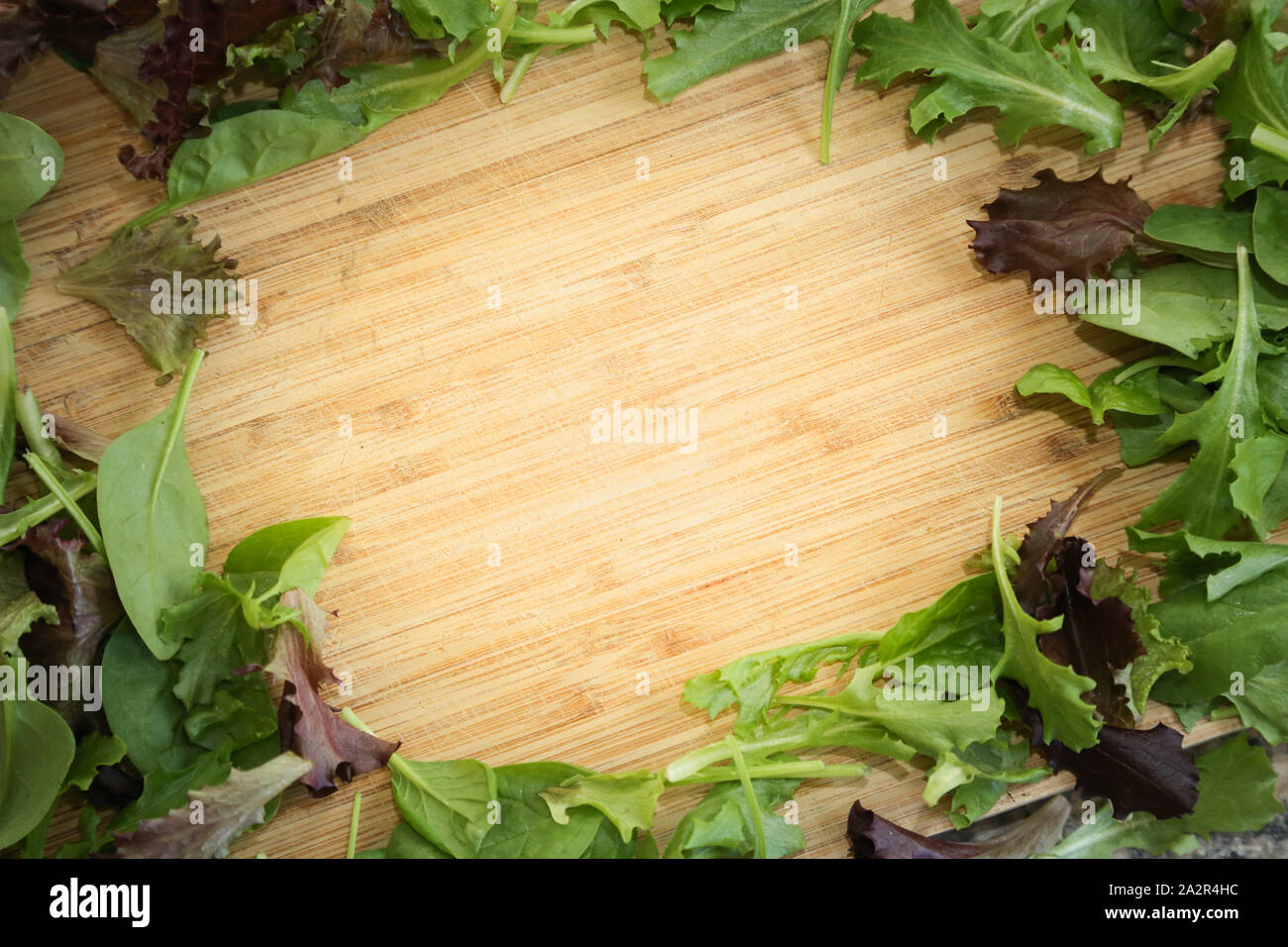 Spring mix lettuce frame, lettuce frame on a chopping board Stock Photo ...