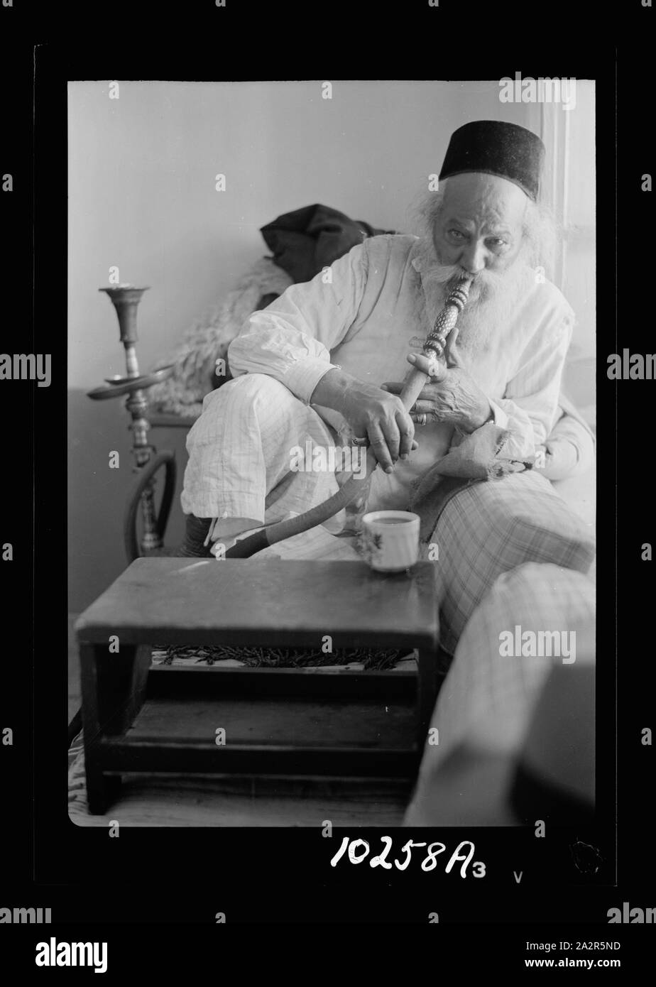 Rabbi Avram at home with nargeli i.e., nargile Stock Photo - Alamy
