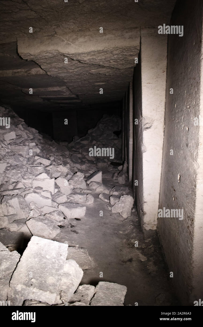 Old underground passage, dungeon, catacombs lined with stones and slabs ...