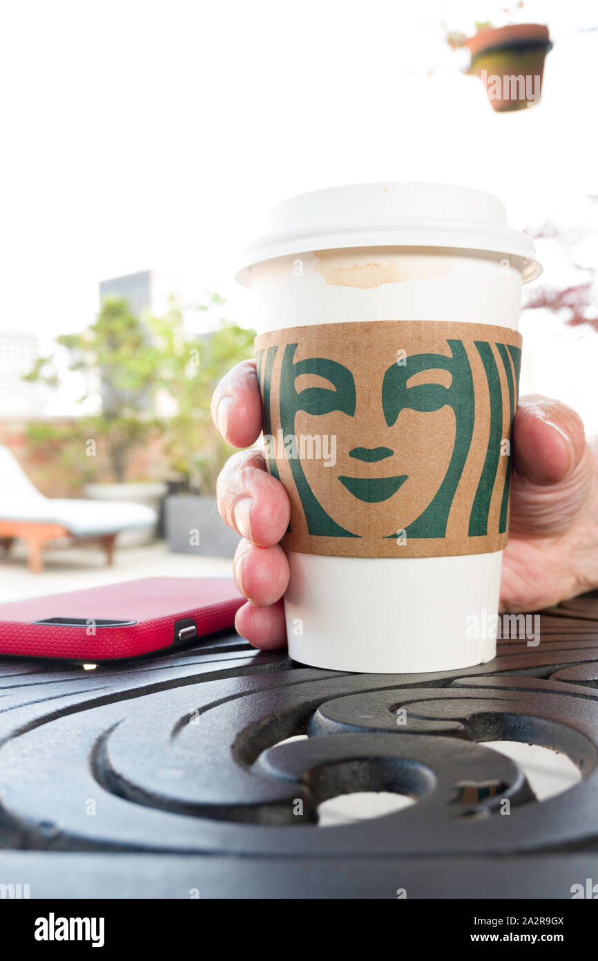 Starbucks Coffee to-go on a patio table, USA Stock Photo - Alamy
