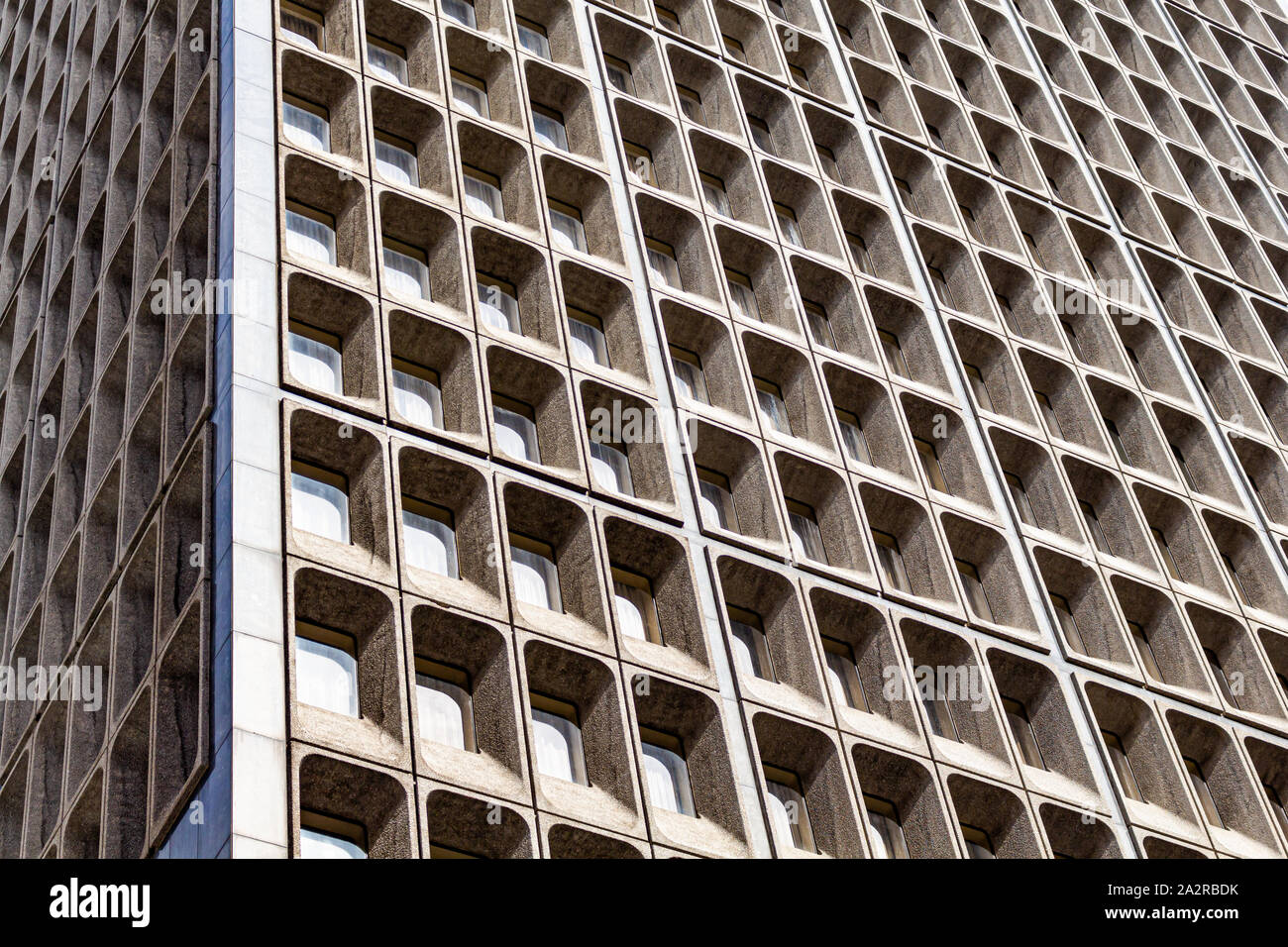 An office building's exterior architecture has indented windows that ...