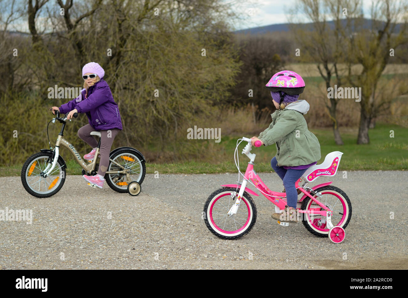 two girl riding a bike Stock Photo - Alamy
