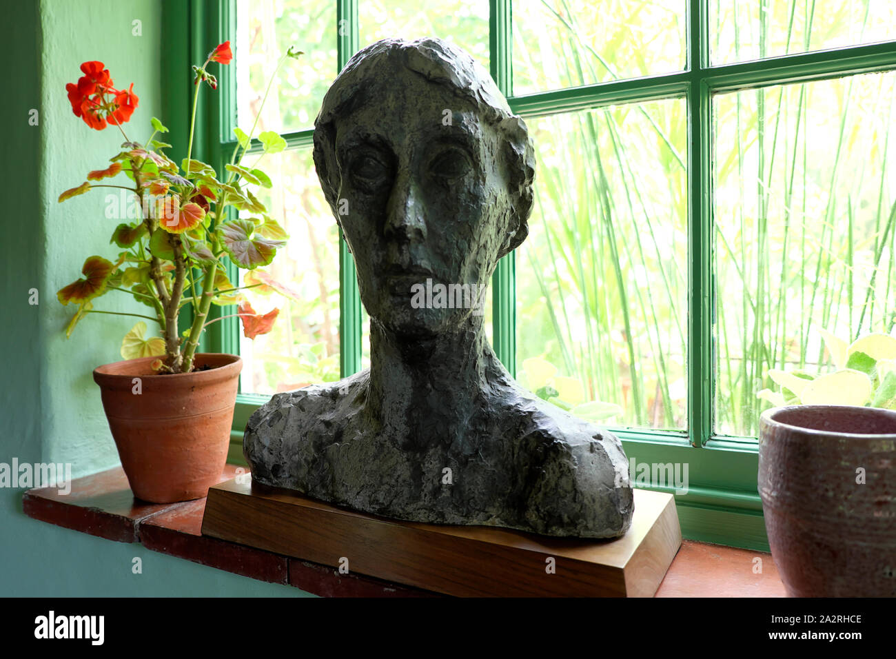 Bust of Virginia Woolf by a red geranium plant on the window ledge at ...