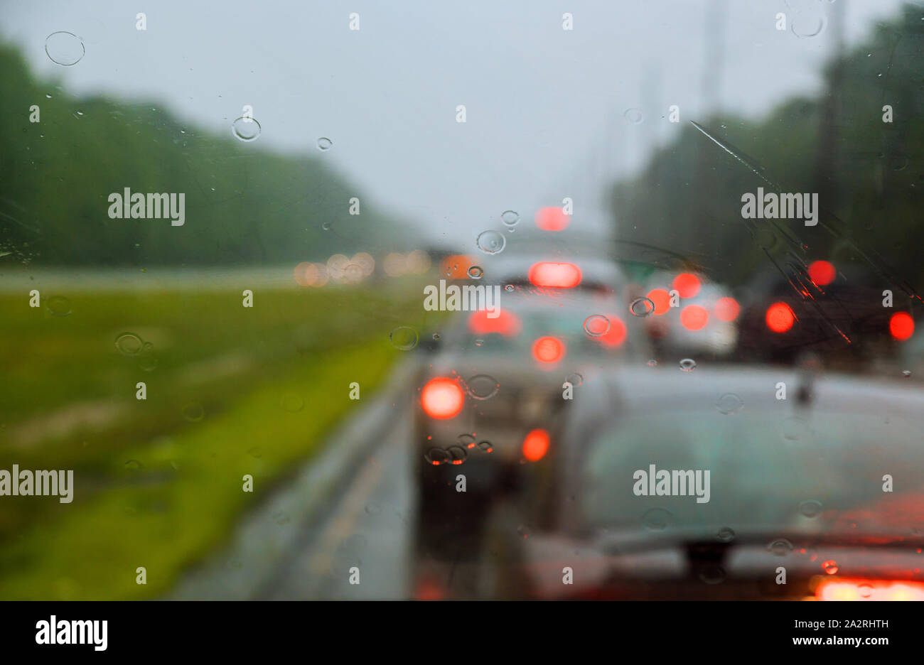 Traffic in rainy day with road car window with rain drops on car Stock ...