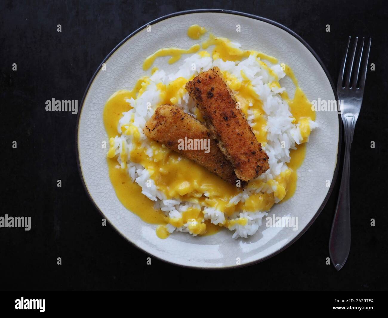Fish fingers, rice and sauce Stock Photo - Alamy
