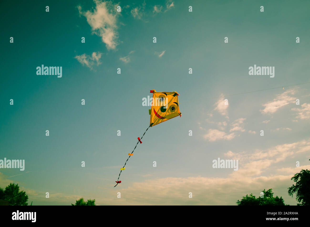 colorful happy smiling kite flying in the sky Stock Photo - Alamy