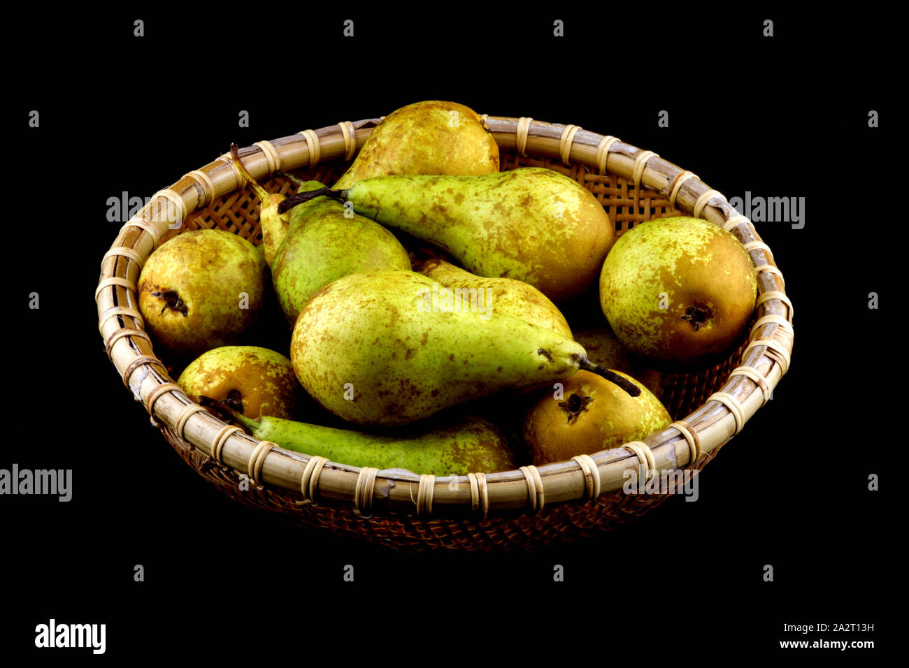 Basket of freshly picked organic pears isolated on black Stock Photo ...