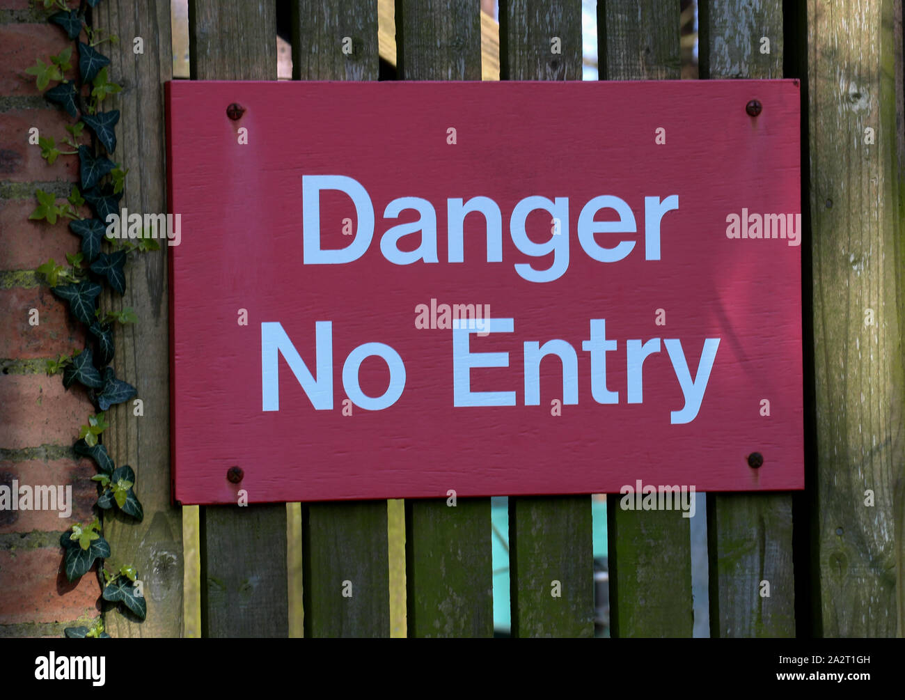 Danger No Entry signboard on an old perimeter wall gate Stock Photo - Alamy