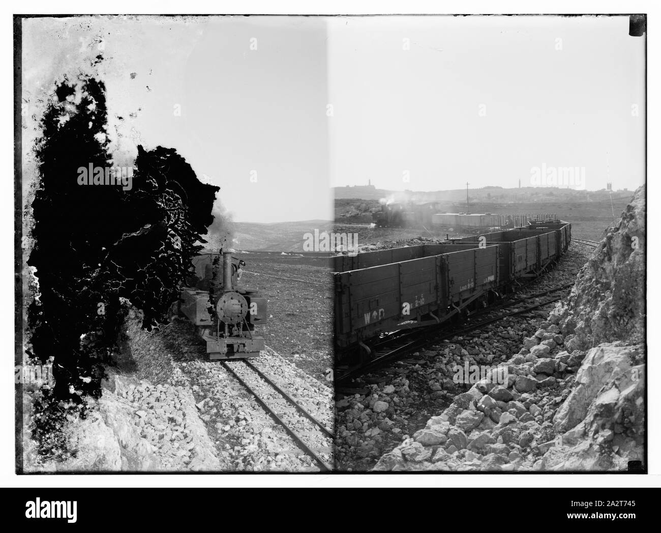 Rear view of military train curving around track near Tomb of the ...