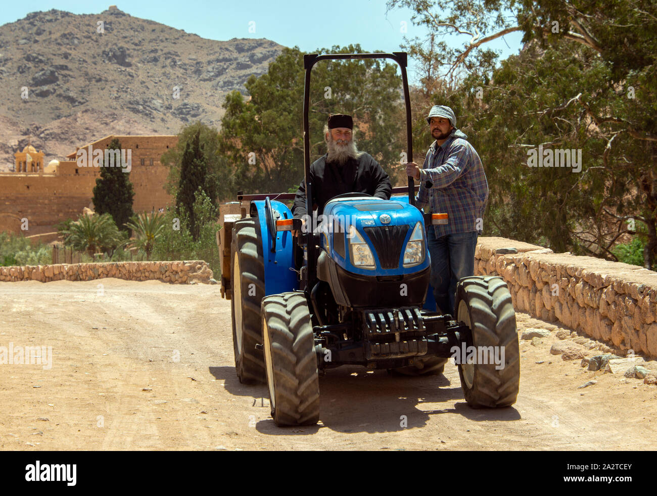 Monk riding tractor at Saint Catherine's Monastery Stock Photo - Alamy