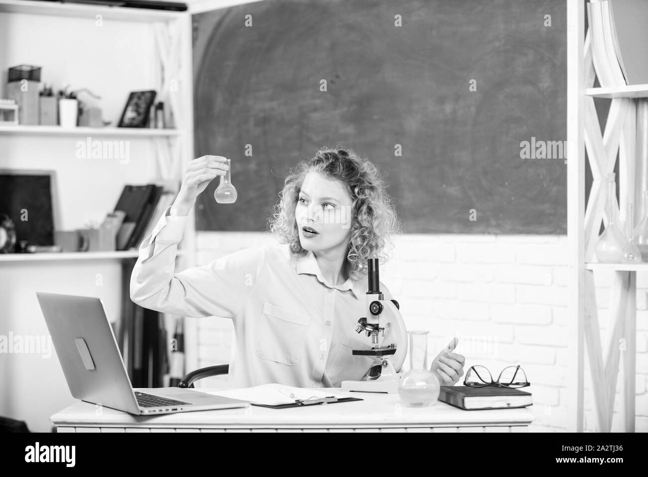 Investigate molecular modifications. Student girl with laptop and ...