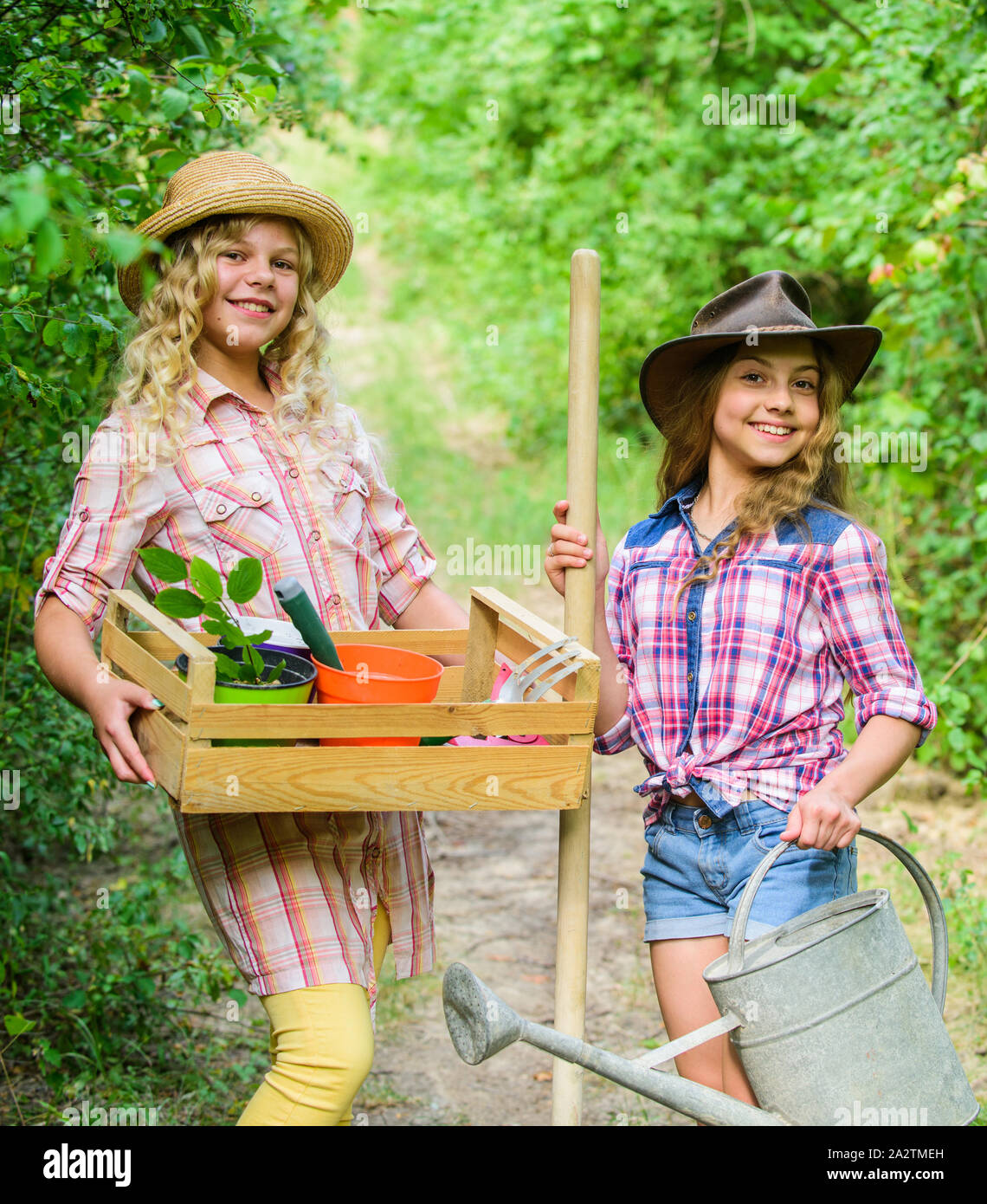 Working with plants. happy children hold gardening tools. farming and ...