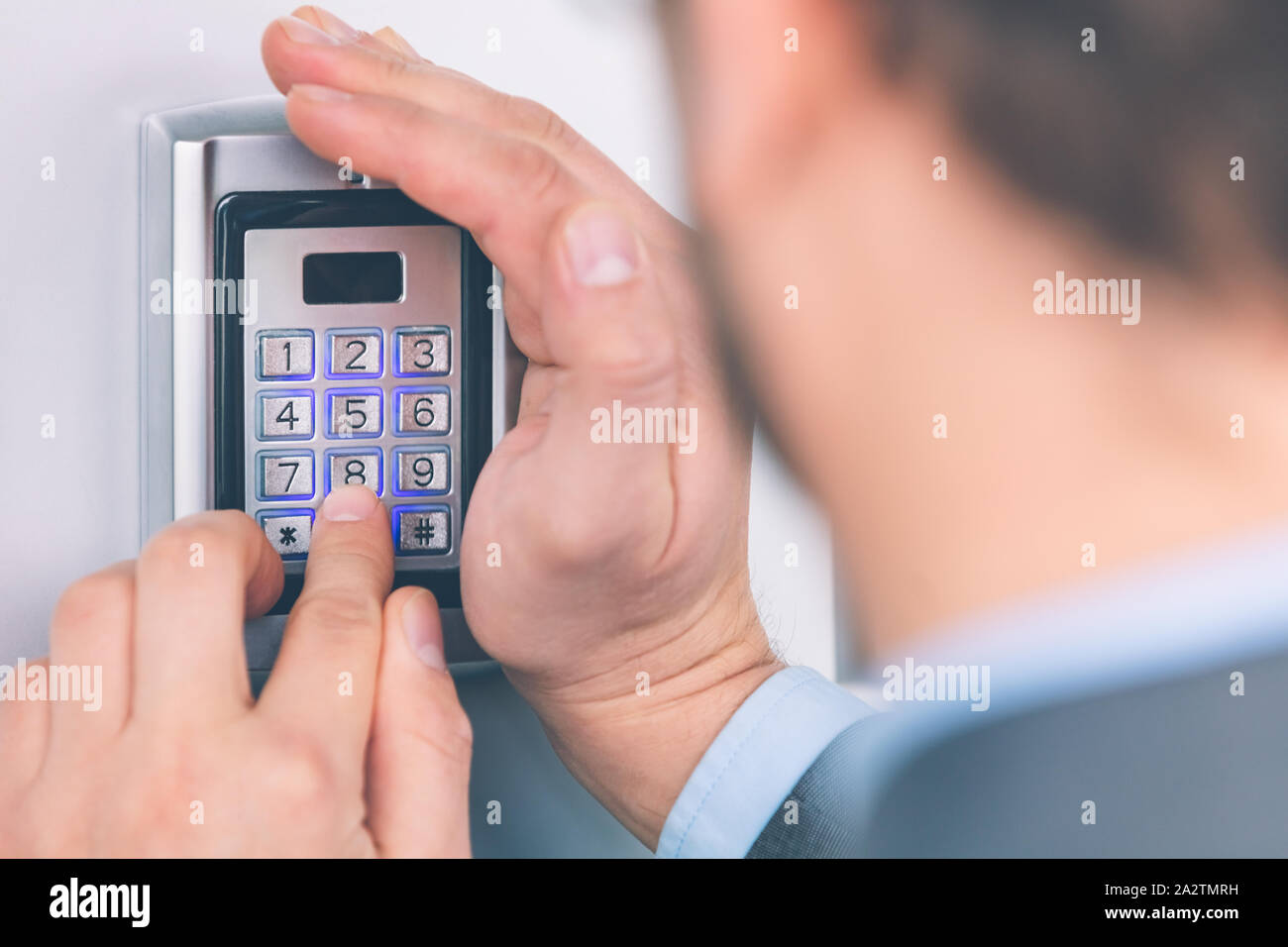 Human hand pressing the security code combination to unlock the door ...