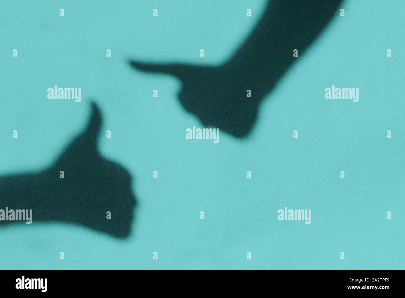 Shadows of two hands with thumb up sign shape on green background ...