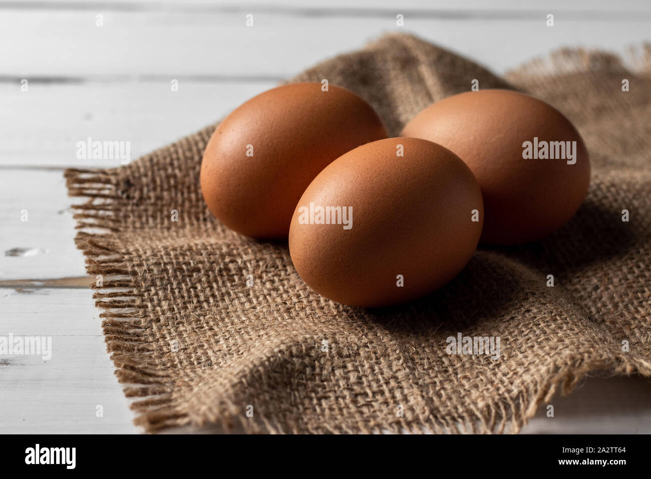 Fresh farm brown chicken eggs over a rustic background Stock Photo - Alamy