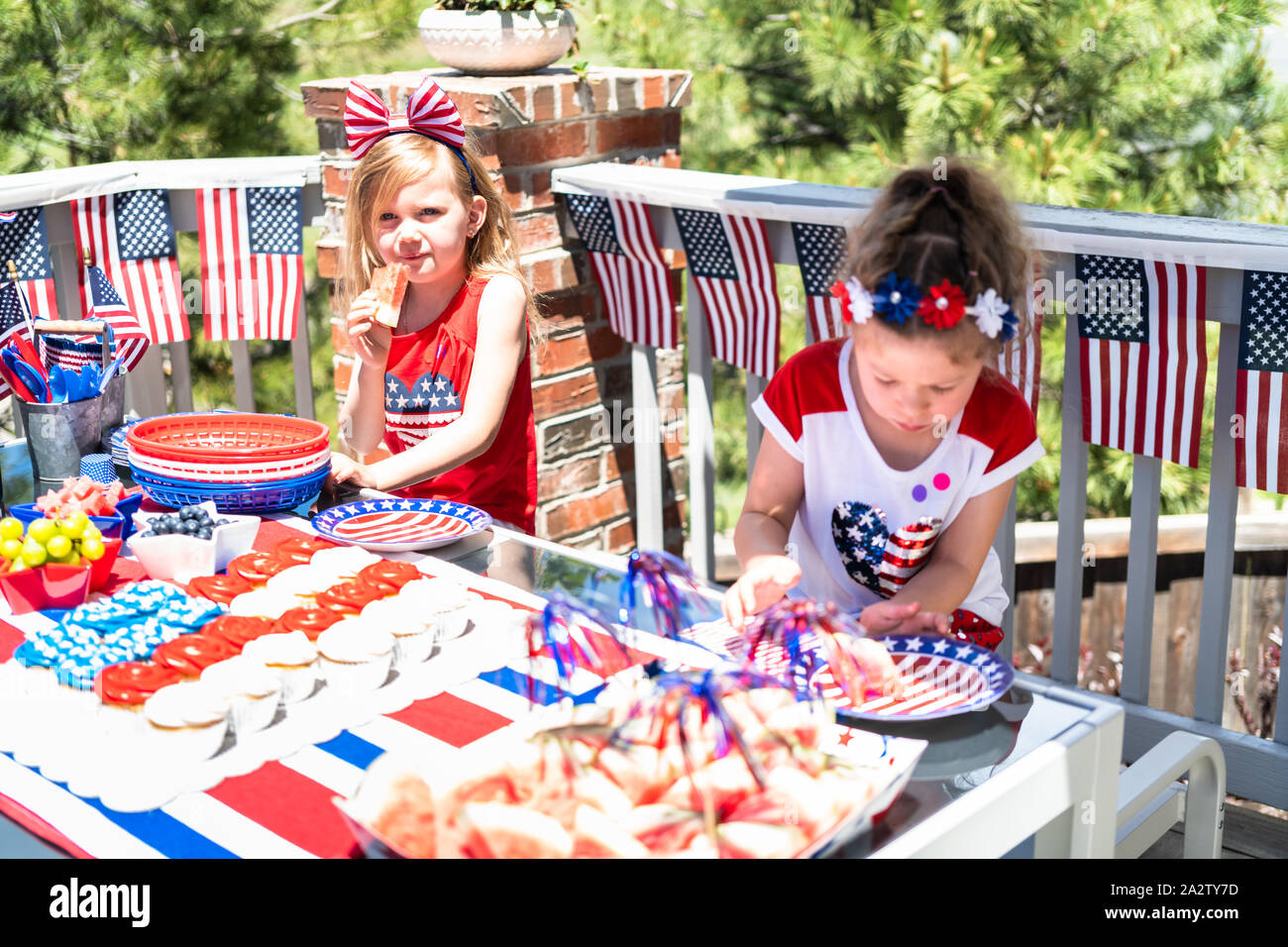 Little girls are playing at the July 4th party on the back patio Stock ...