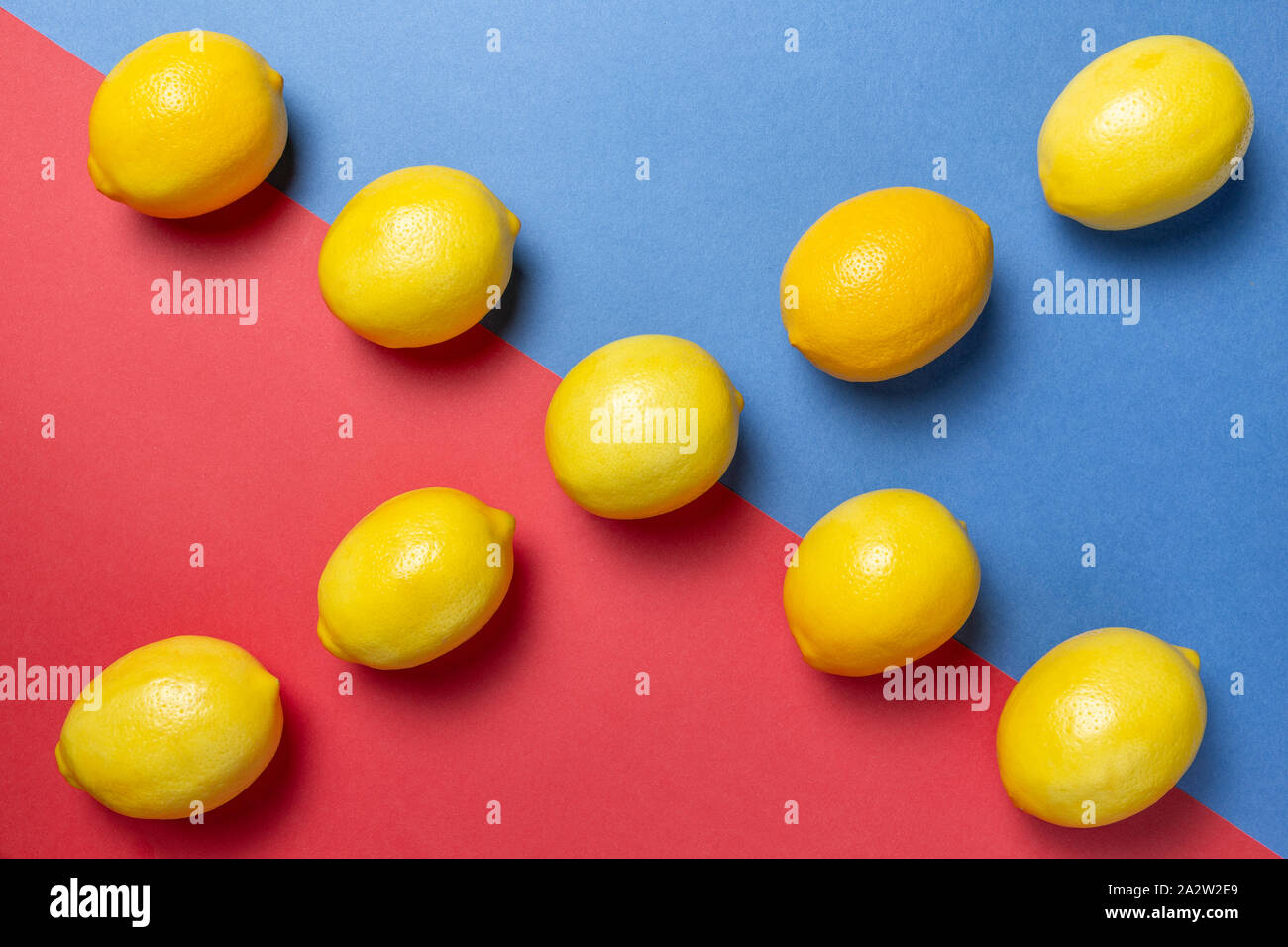 Lemons on the bicolor red and blue background. Flat lay citrus ...