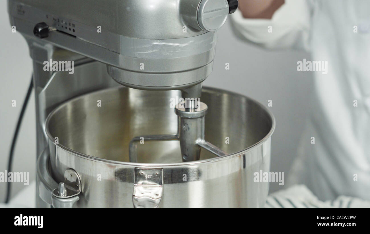 Step by step. Mixing ingredients in standing kitchen mixer to bake ...