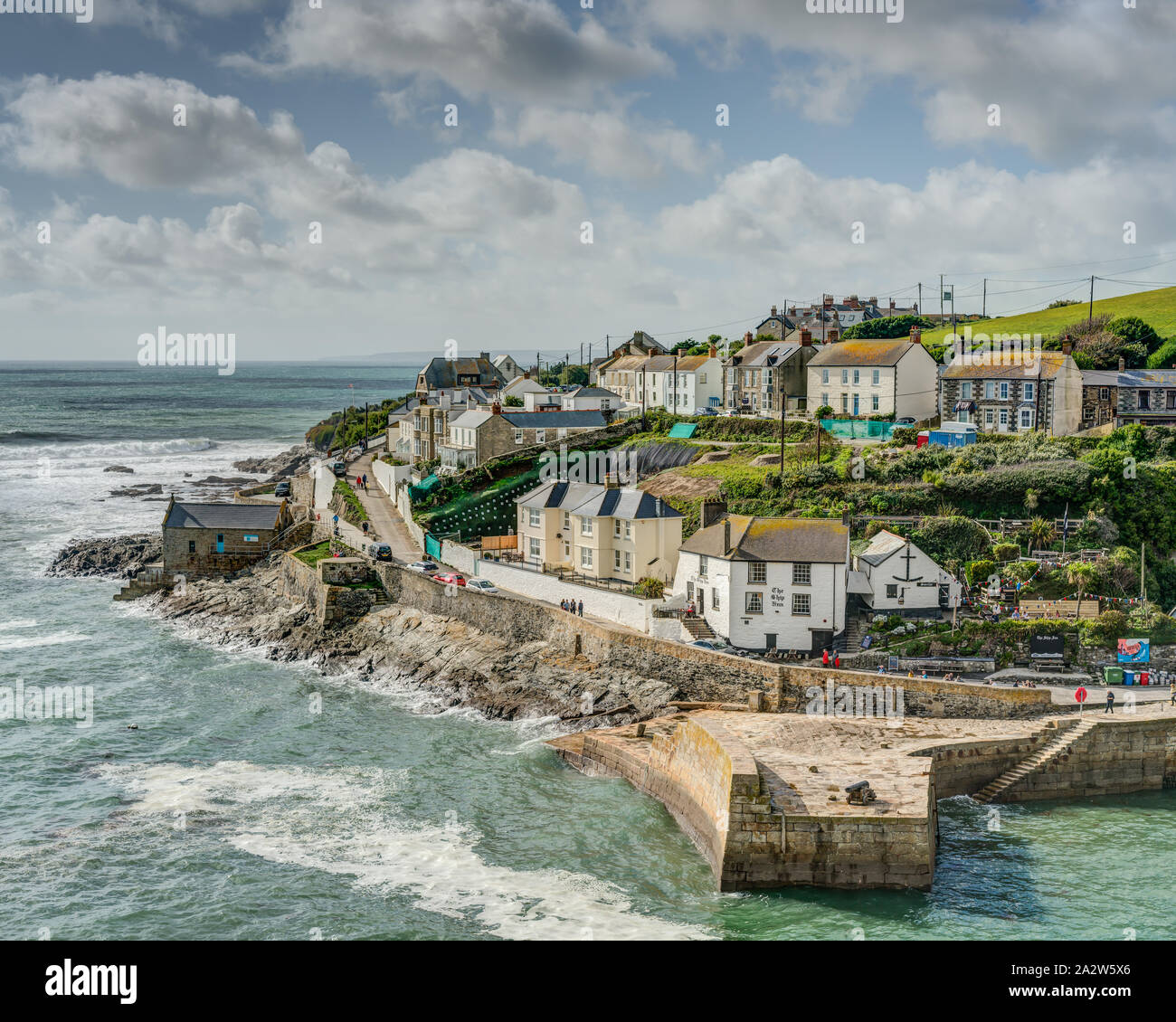 A pretty coastal scene shows the west side of Porthleven harbour near ...