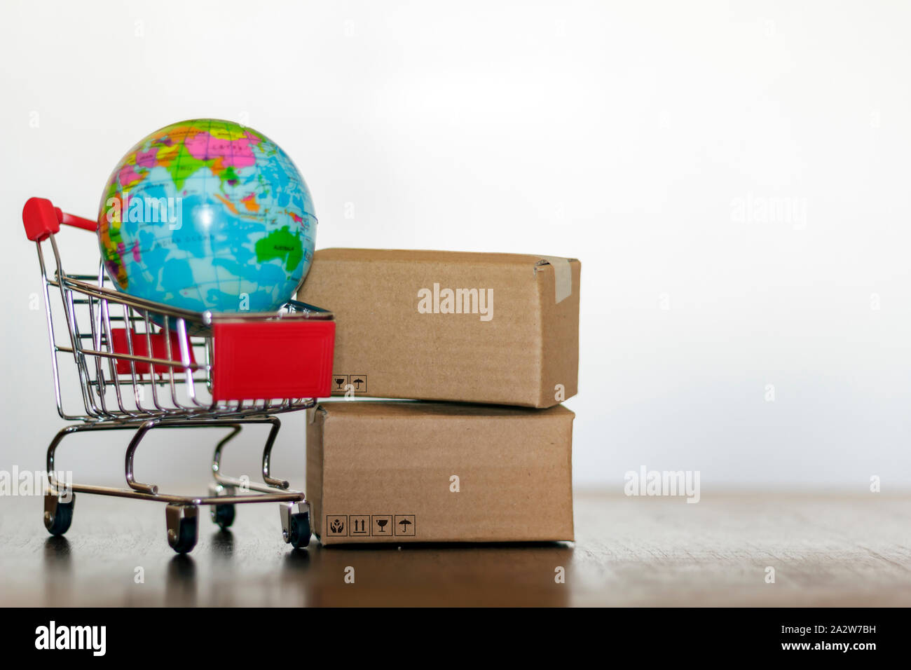 Shopping cart carton and earth globe. International shopping and global ...
