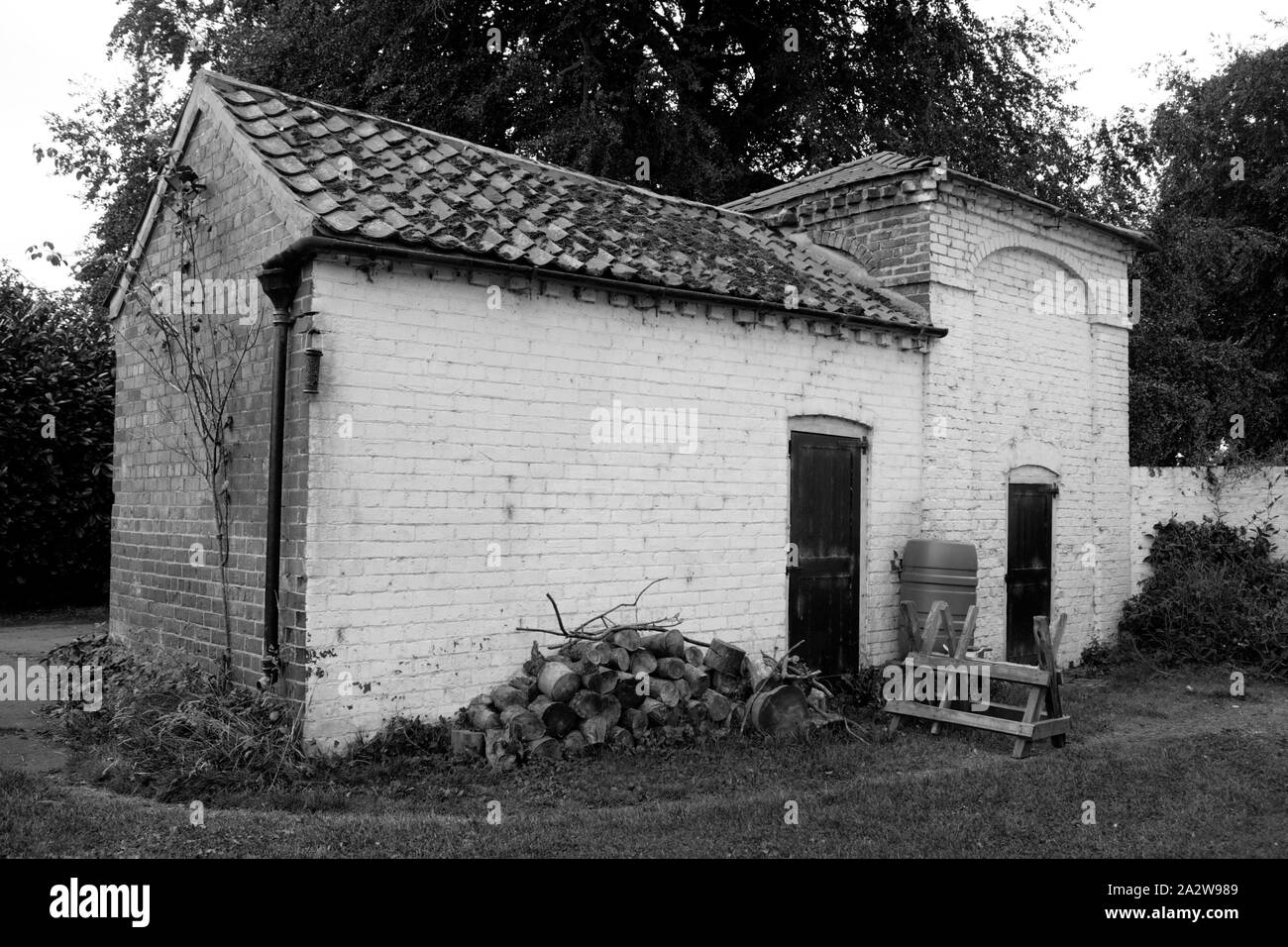 Old Rural Historic Brick Outbuilding with Log Pile, Water Butt and ...