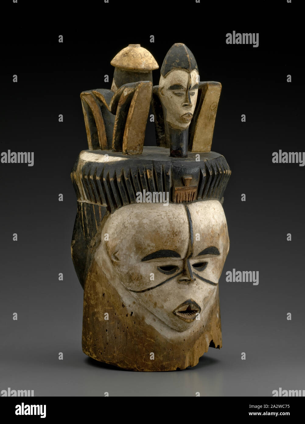 Janus-faced helmet mask with two human head finials, pigment, H: 19 in ...