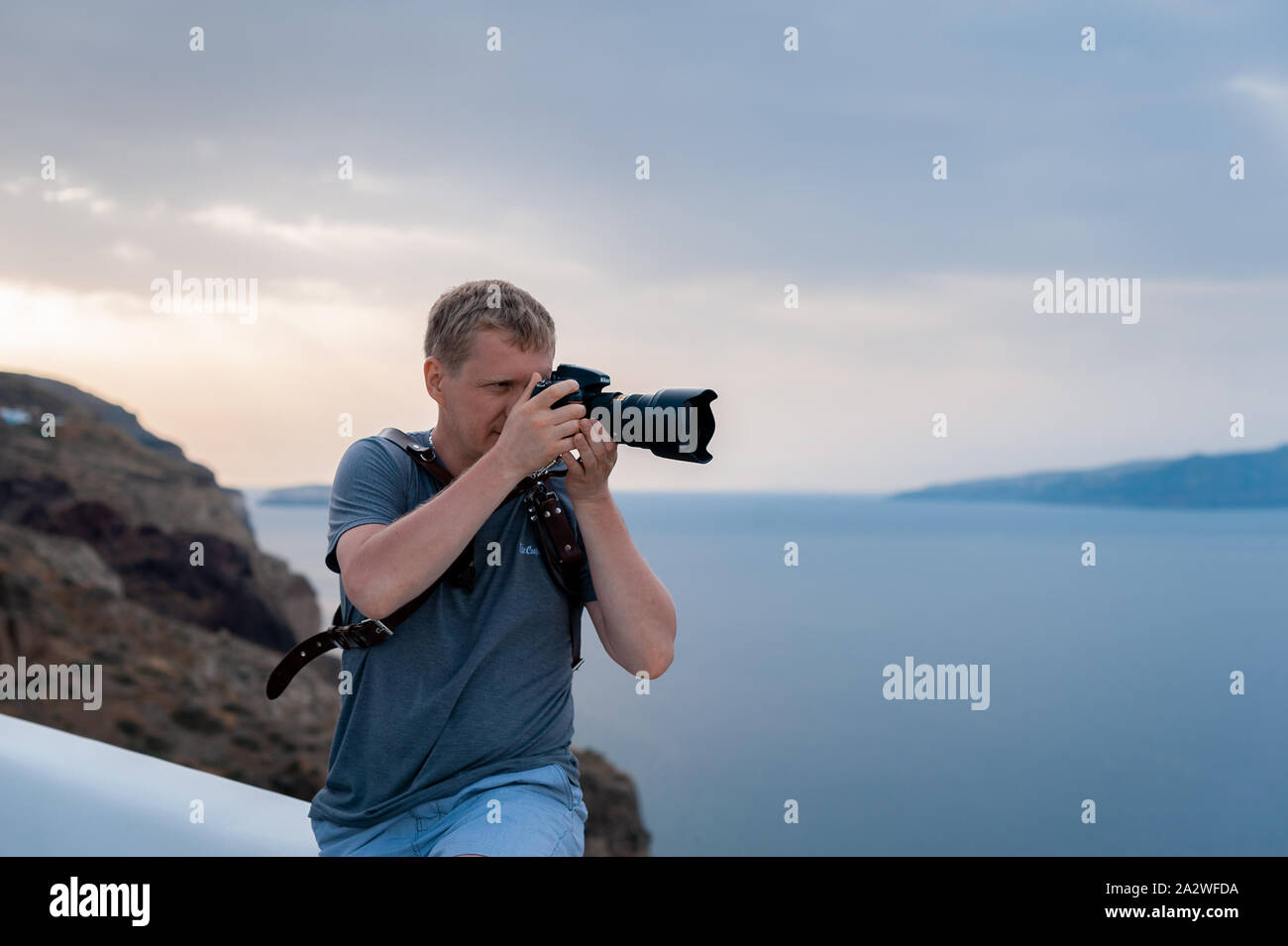 Photographer traveler takes picture caldera and Santorini island in ...