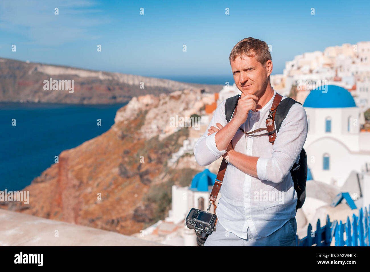 Man photographer taking pictures of Santorini, Greece. Shooting. Camera ...